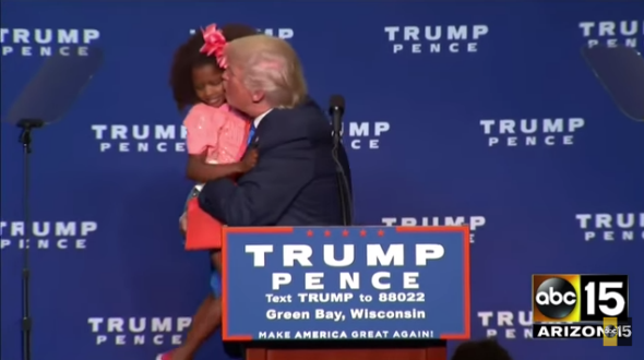 Donald Trump tried to kiss a little girl on the lips as she squirmed away.