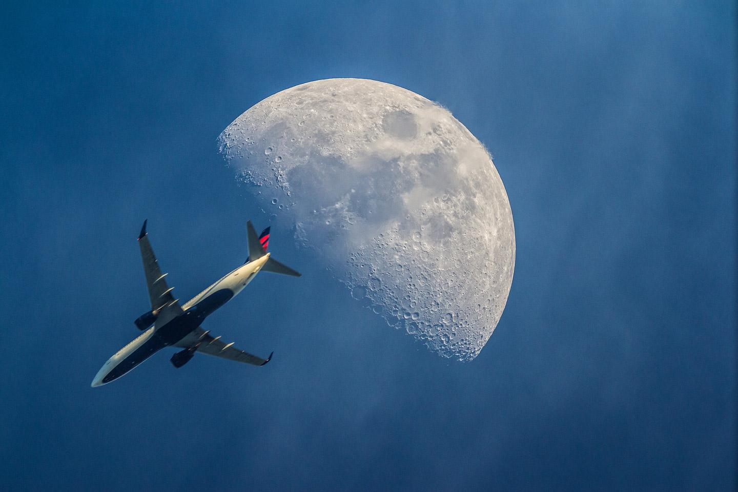 Plane luck: Photo of an airplane in front of the Moon.