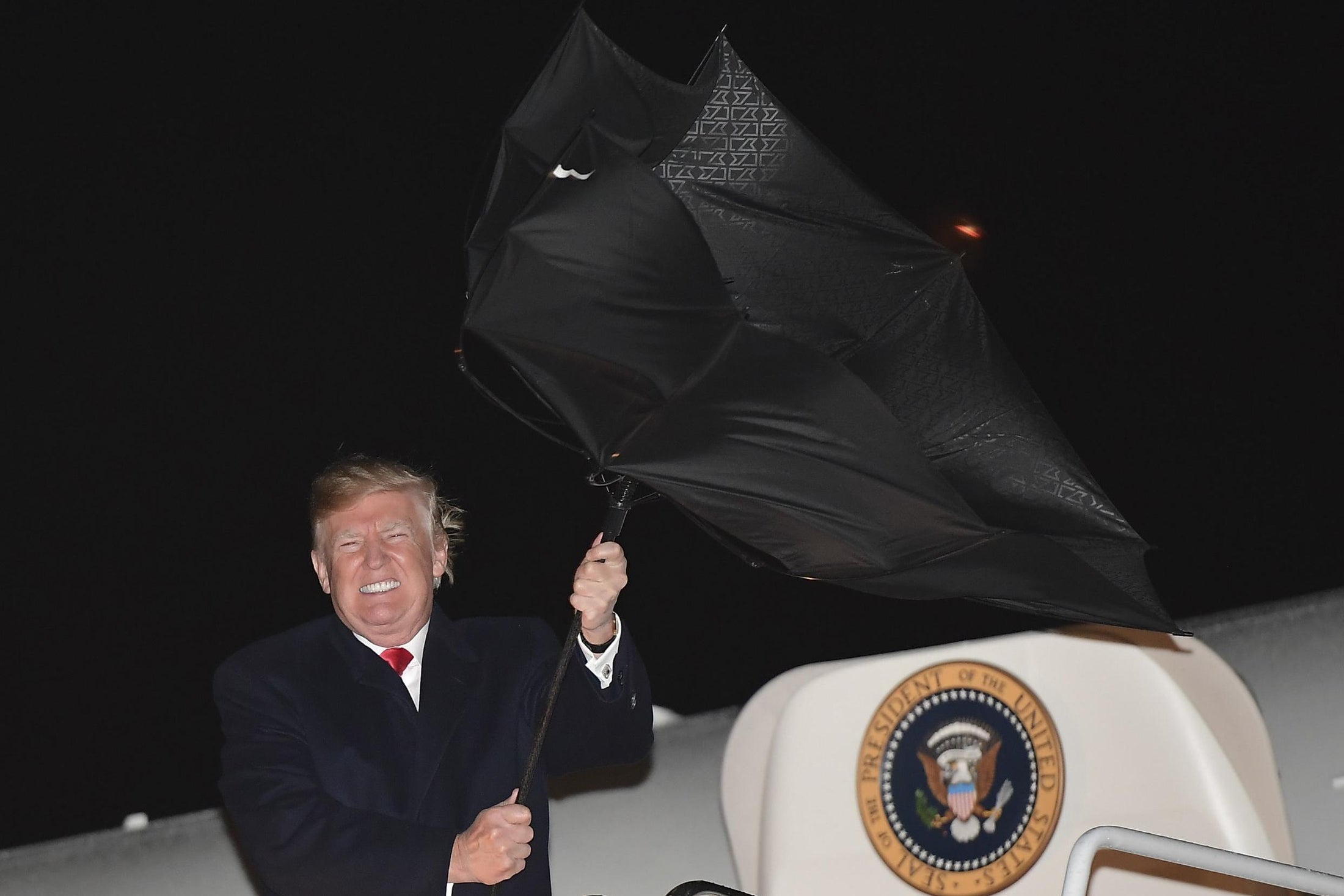 Watch Trump struggle and fail to control unruly umbrella as metaphor ...