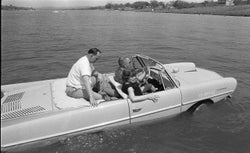 Lyndon Johnson drives in a lake in his Amphicar (PHOTO).