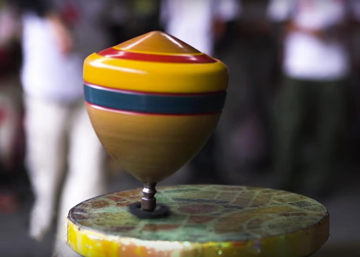 A group of men in Taiwan perform a series of impossible spinning top ...