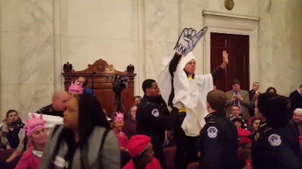 Sessions hearing: KKK costume protesters ejected.