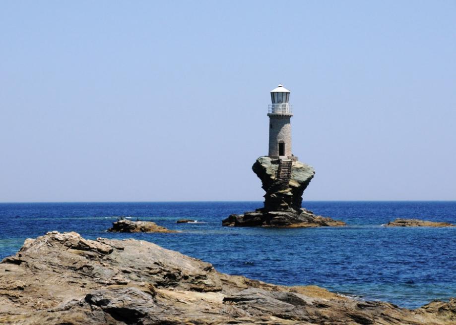 The Tourlitis Lighthouse in Greece, rising out of an eroded sea spire ...